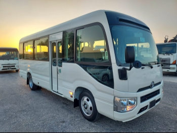 Toyota Coaster White BUS For Rent in QAR
